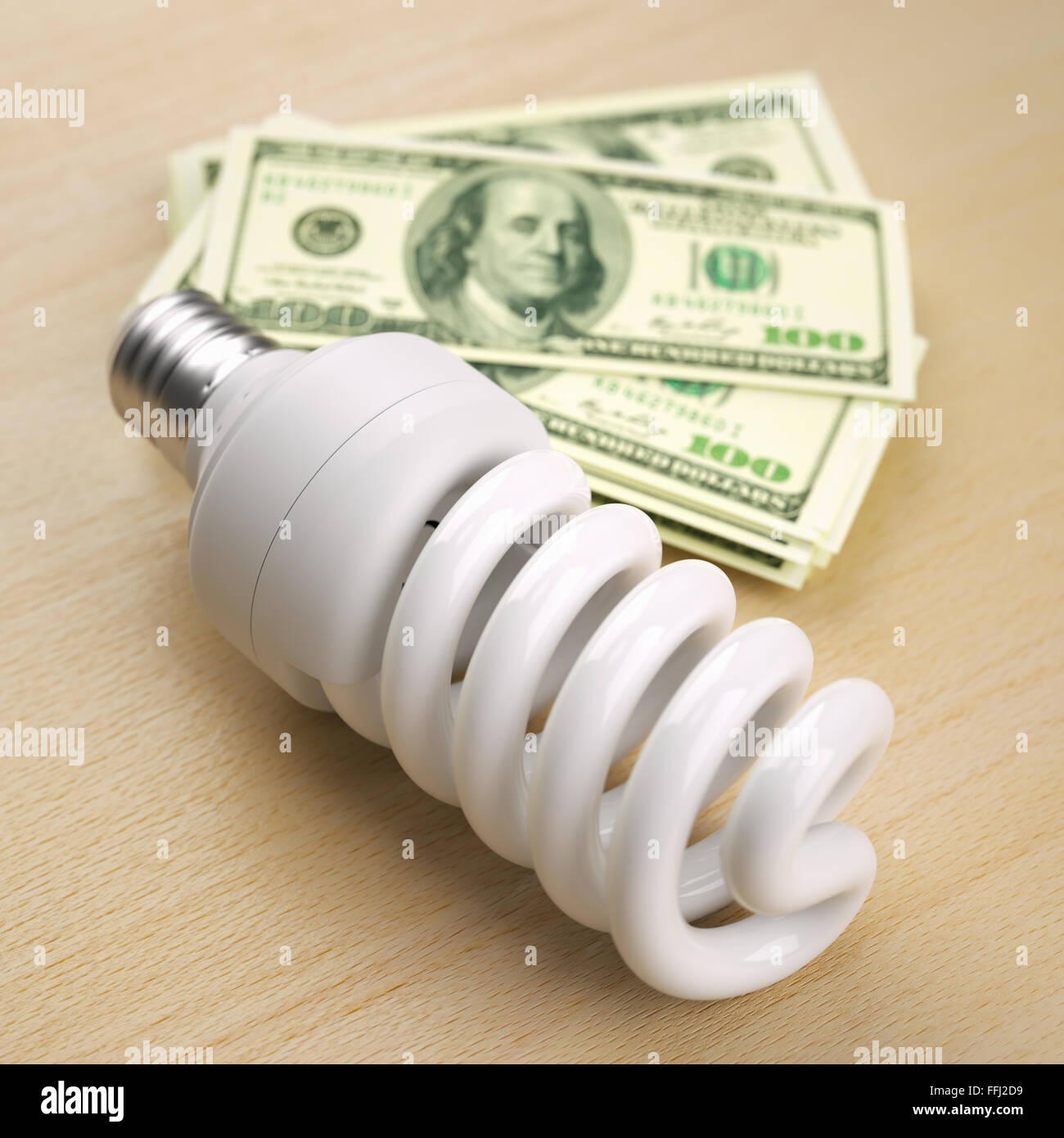 Compact fluorescent light bulb in front of one hundred dollar bill ...