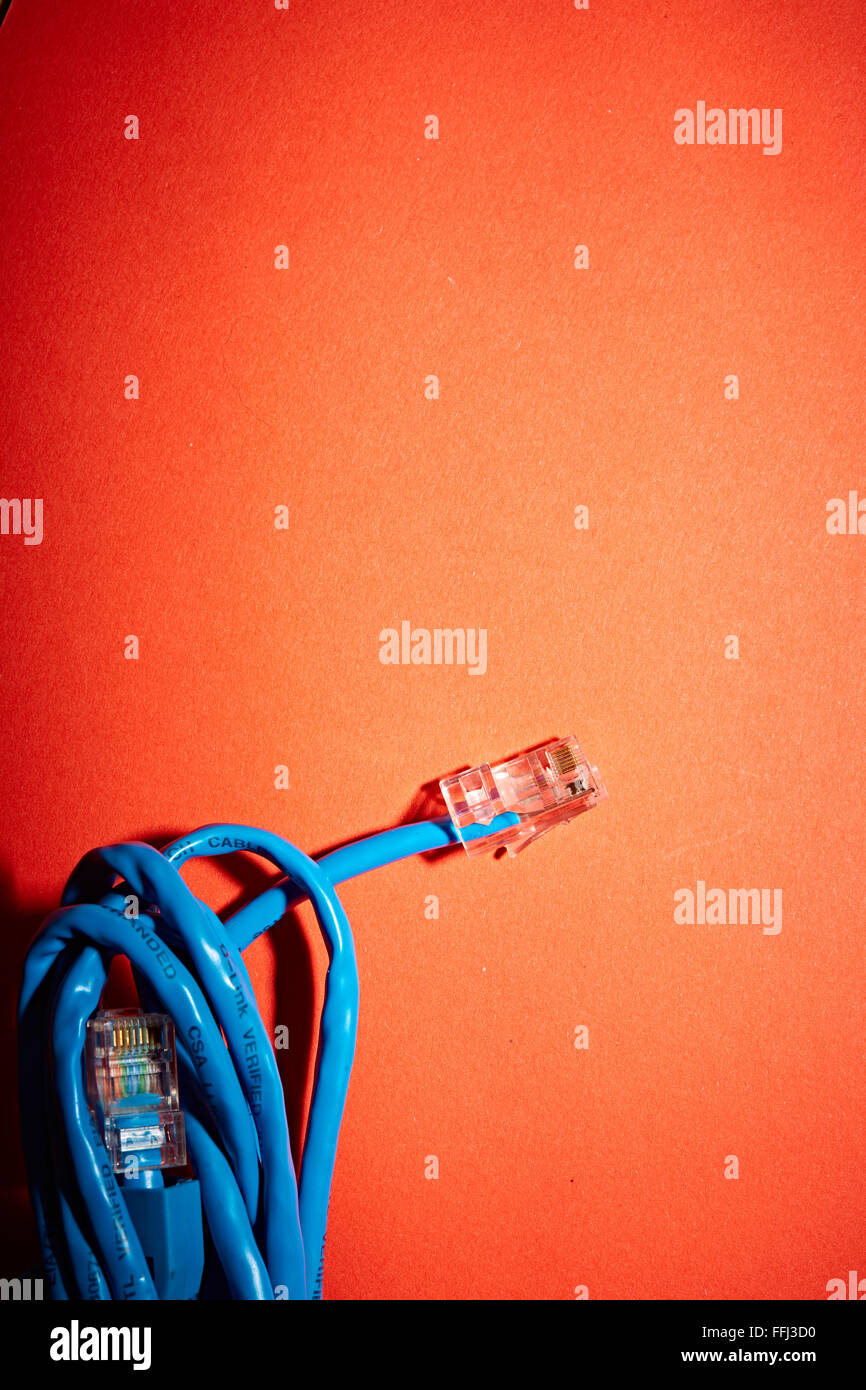Blue network cable on red background Stock Photo - Alamy