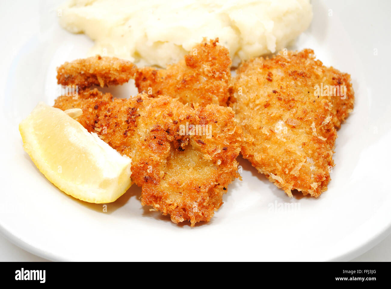 Fried Cat Fish Served with a Wedge of Lemon Stock Photo - Alamy