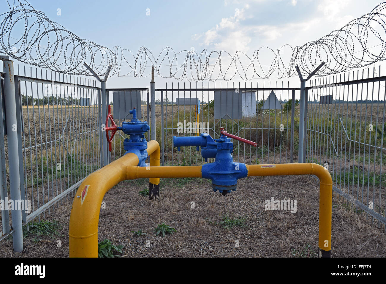 The latch on the underground gas pipeline protected with a fence Stock ...
