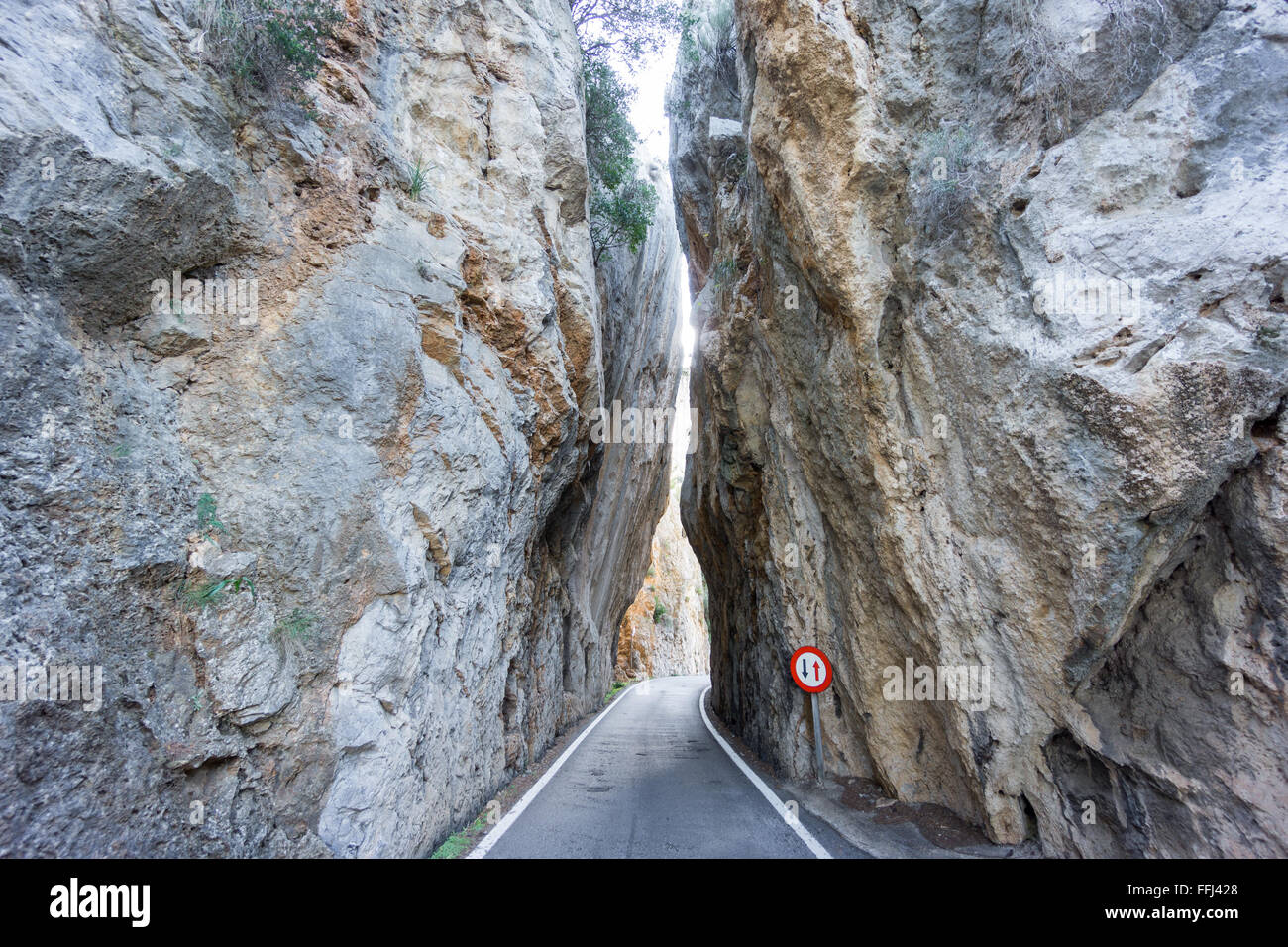 Asphalt road between rocks, wild track Stock Photo - Alamy
