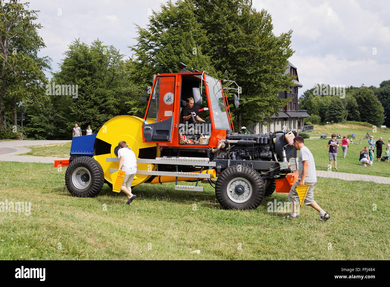 Yellow tractor towing a winch cable, Bieszczady Bezmiechowa, National ...