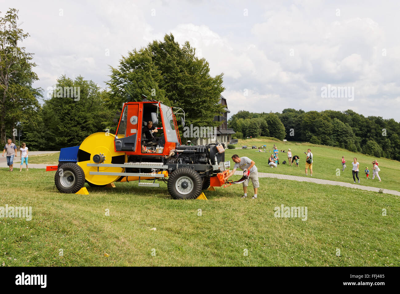 Yellow tractor towing a winch cable, Bieszczady Bezmiechowa, National ...