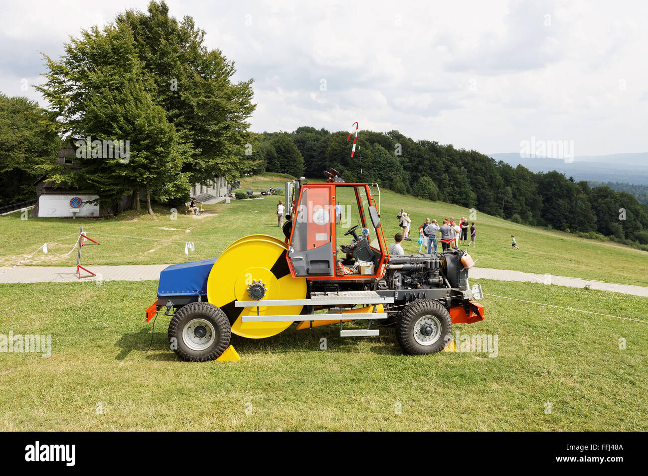 Yellow tractor towing a winch cable, Bieszczady Bezmiechowa, National ...