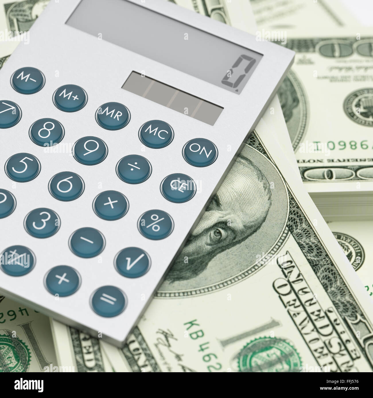 Calculator on 100 dollar banknotes Stock Photo - Alamy
