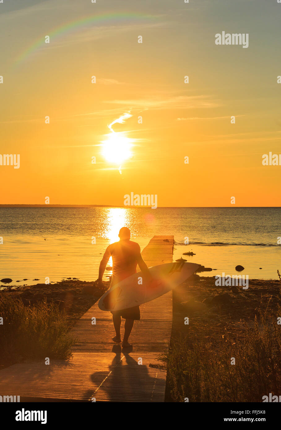 Man Surfing sunset Stock Photo - Alamy