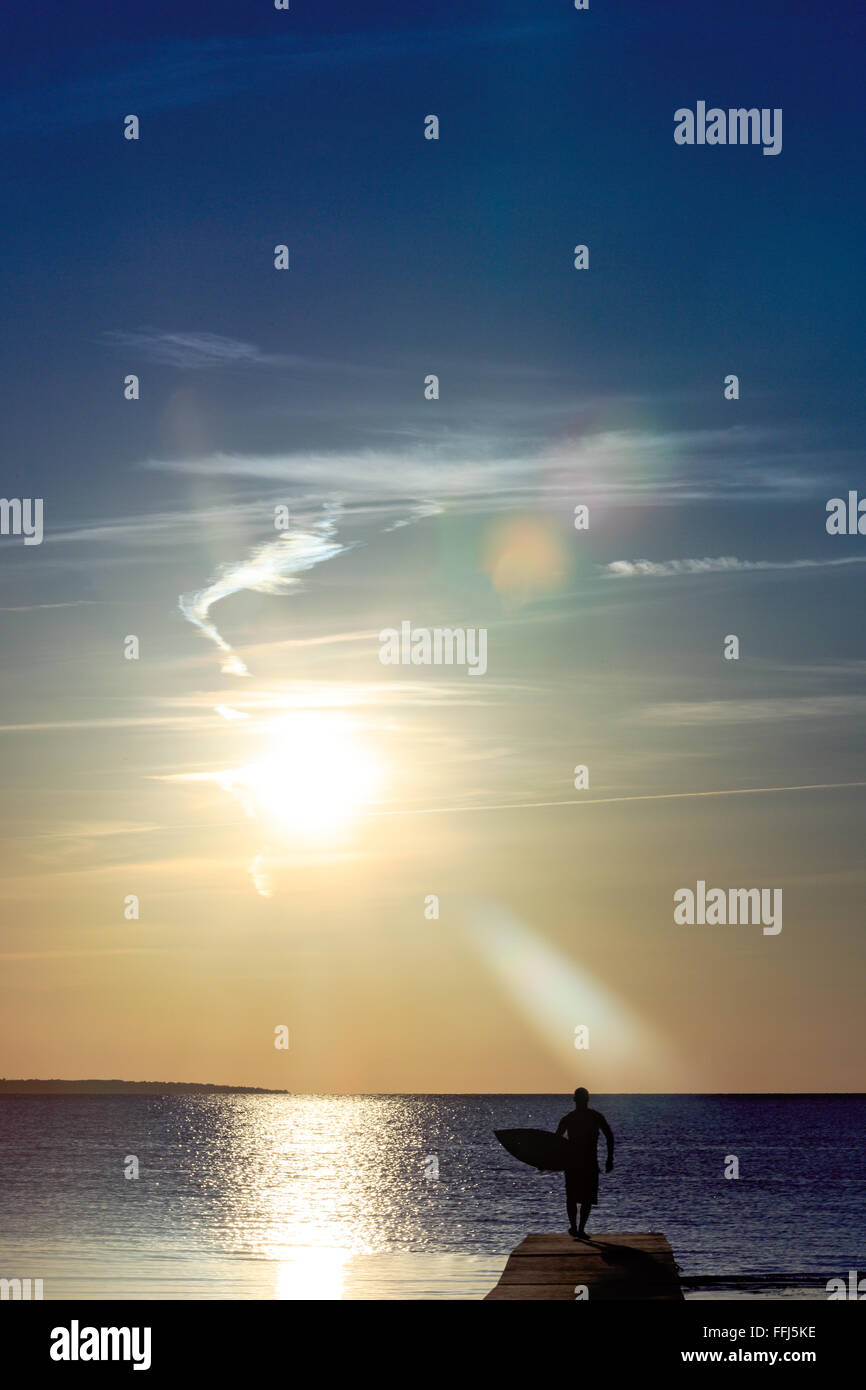 Man Surfing sunset Stock Photo - Alamy