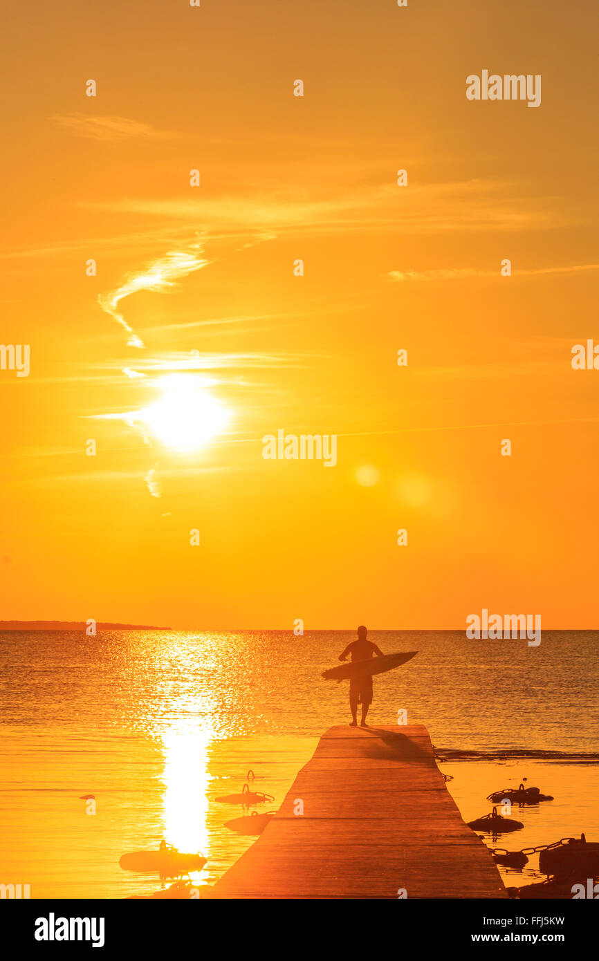 Man Surfing sunset Stock Photo - Alamy