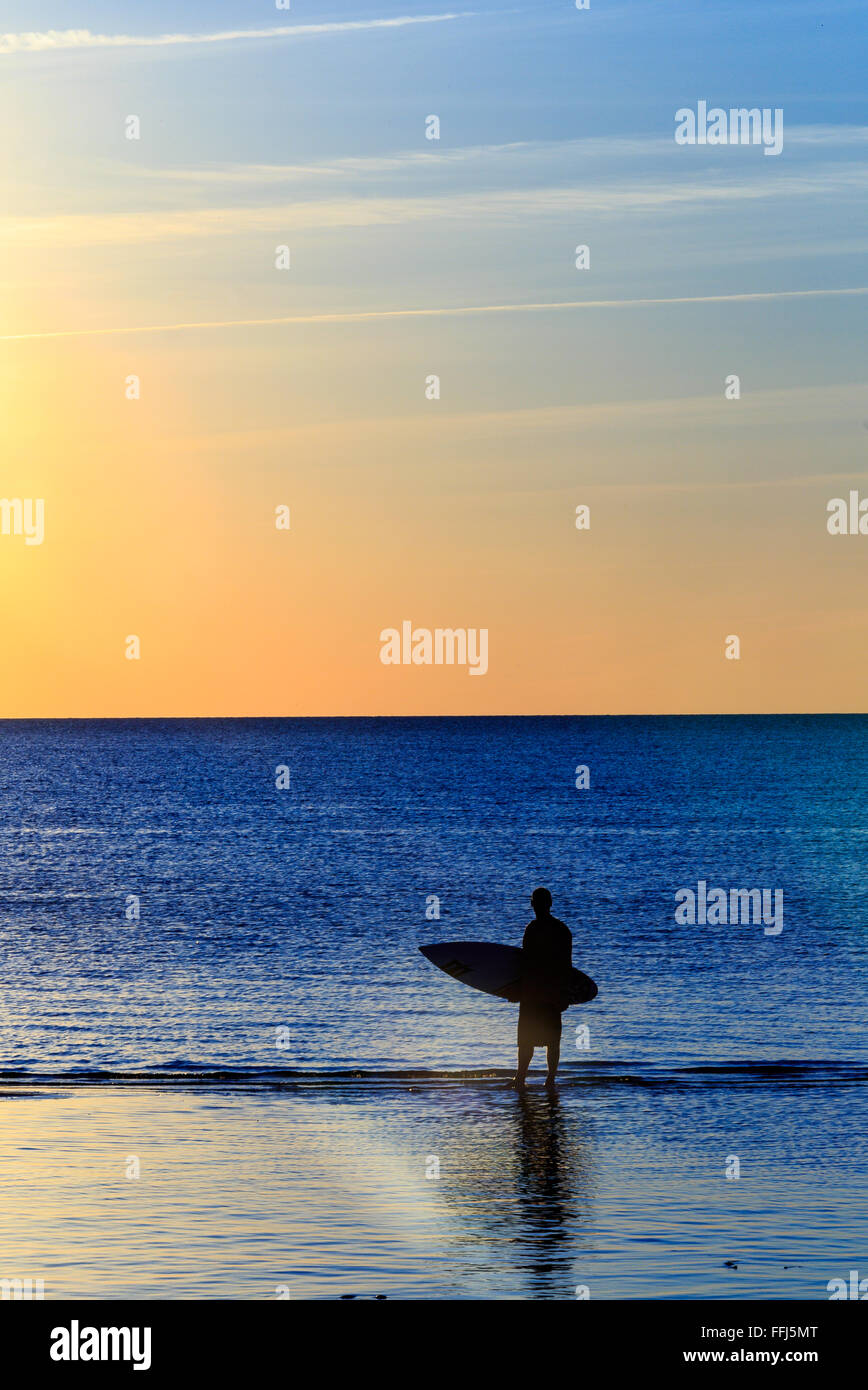 Man Surfing sunset Stock Photo - Alamy