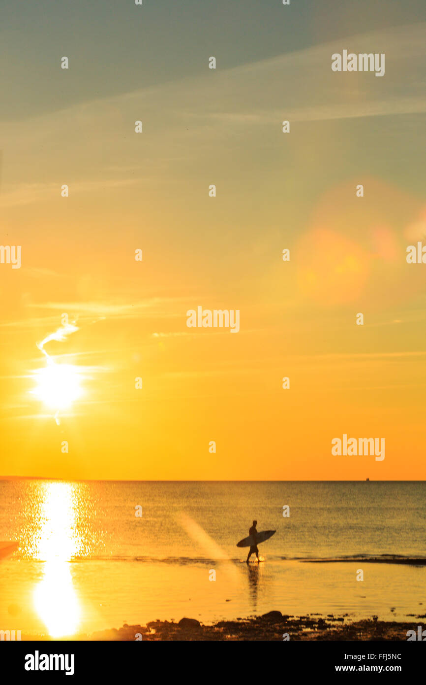 Man Surfing sunset Stock Photo - Alamy