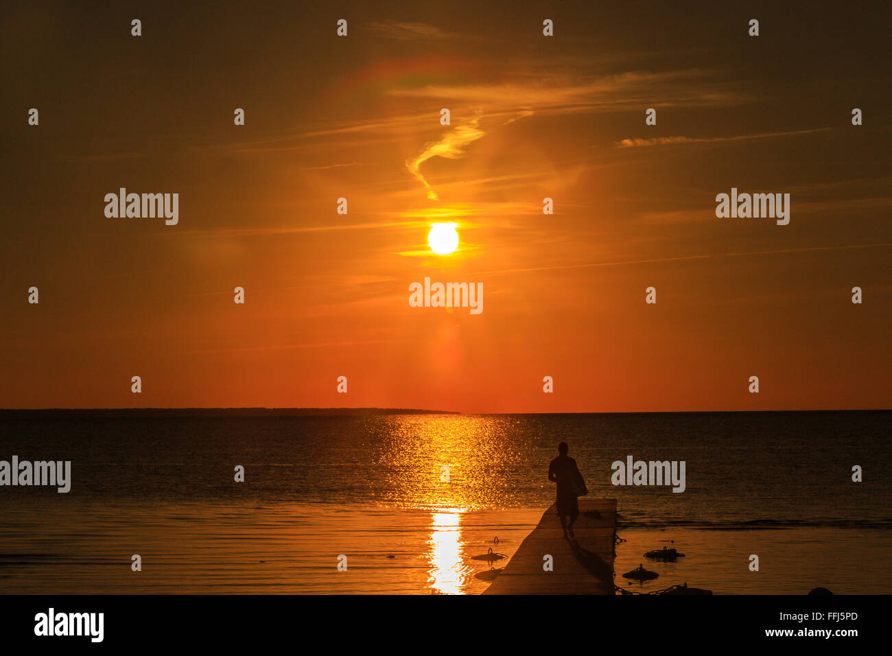 Man Surfing sunset Stock Photo - Alamy