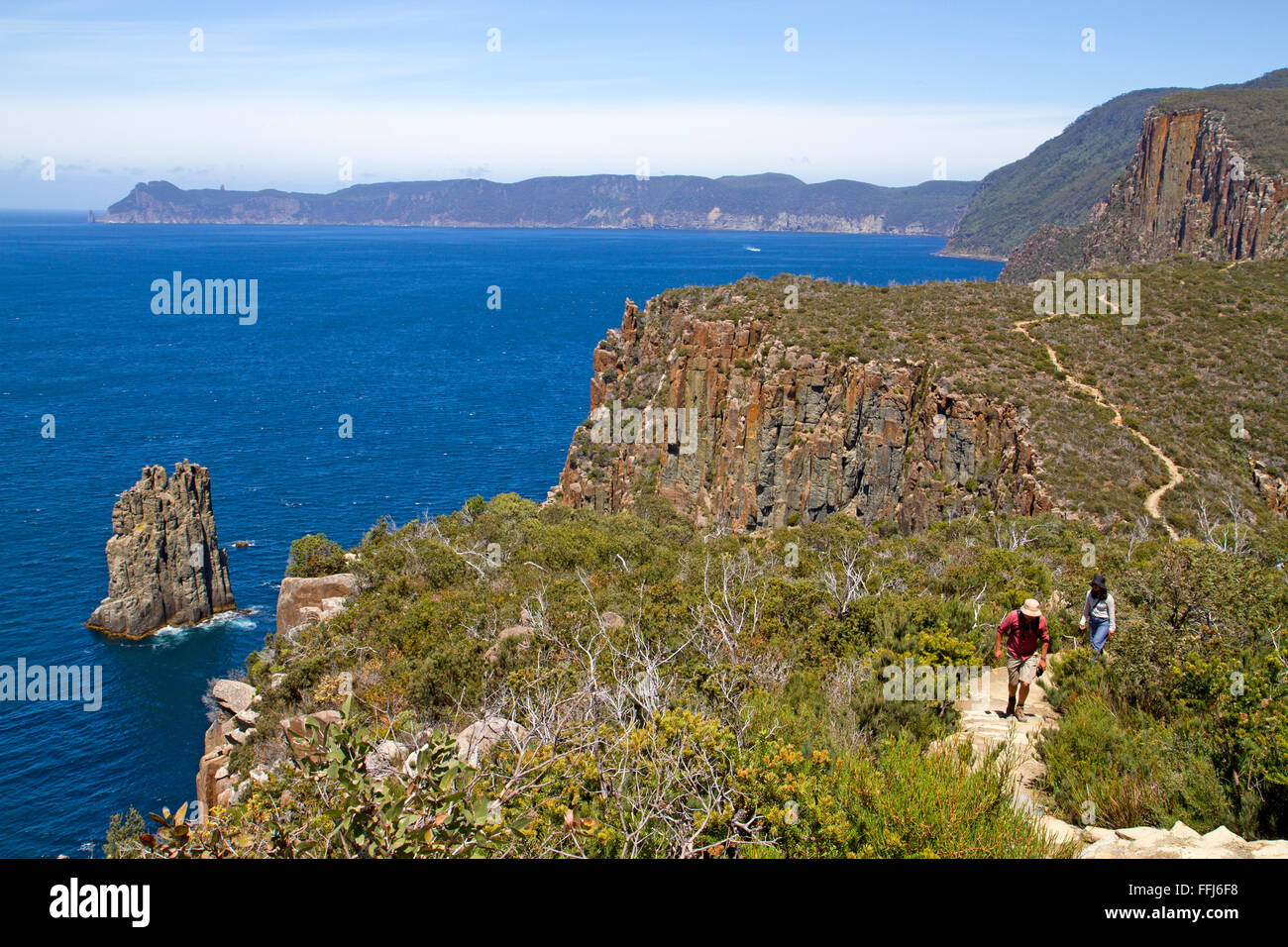 Hikers approaching Cape Hauy on the Three Capes Track, with Cape Pillar ...