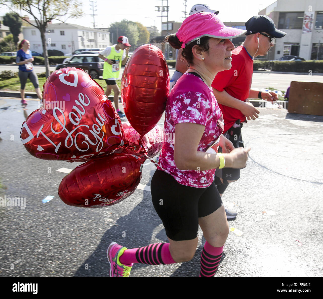 Los Angeles, California, USA. 14th Feb, 2016. Runners make their way ...