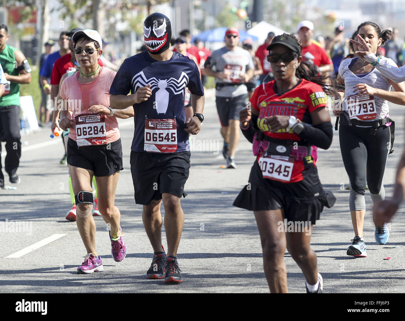 Los Angeles, California, USA. 14th Feb, 2016. Runners make their way ...