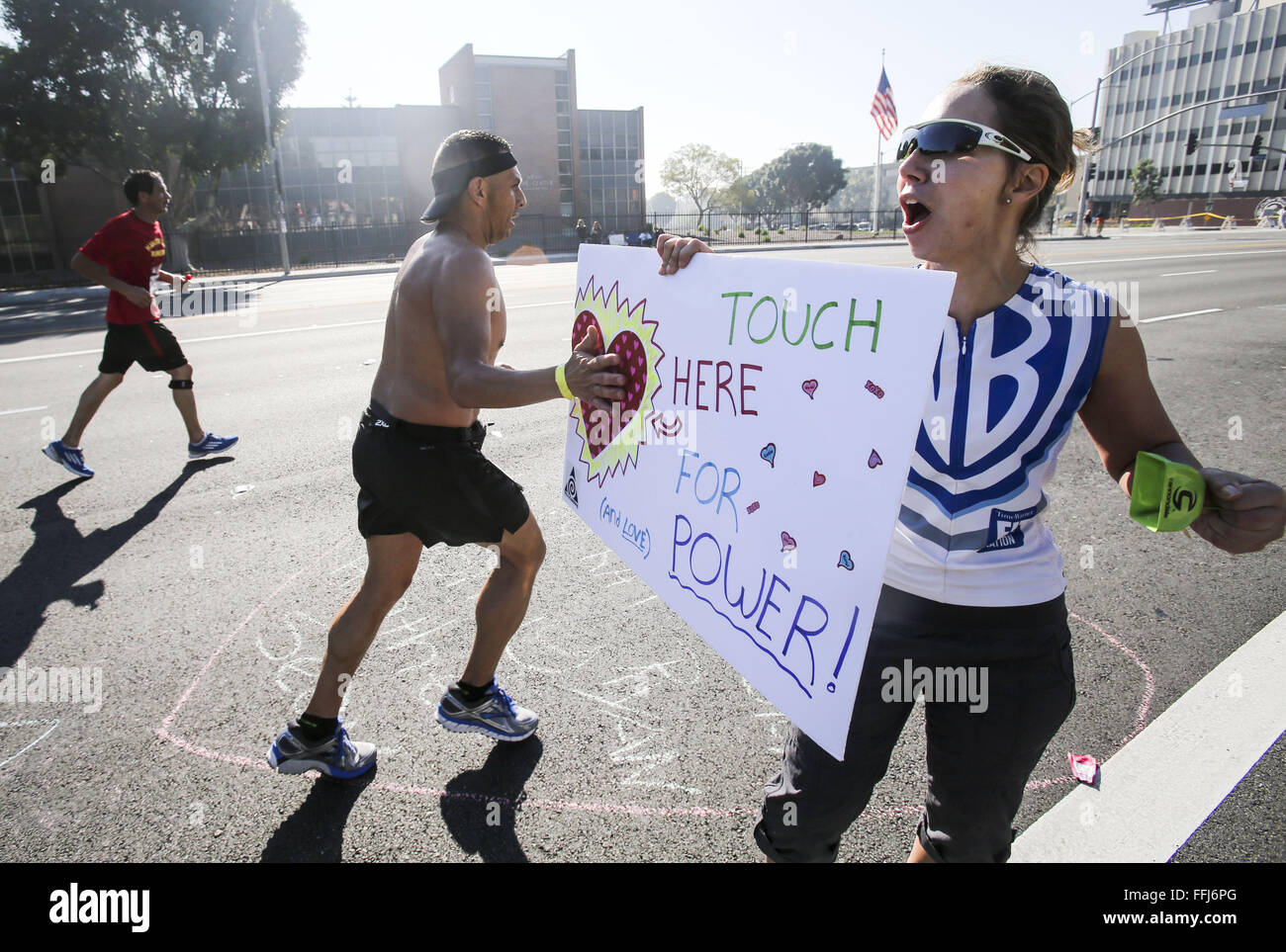 Los Angeles, California, USA. 14th Feb, 2016. Runners make their way ...