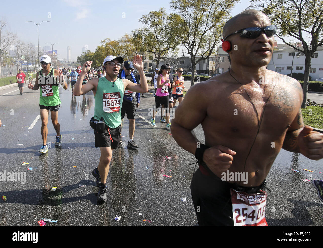 Los Angeles, California, USA. 14th Feb, 2016. Runners run through a ...