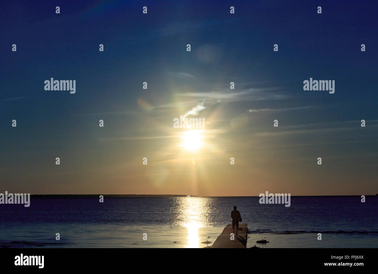Man Surfing sunset Stock Photo - Alamy