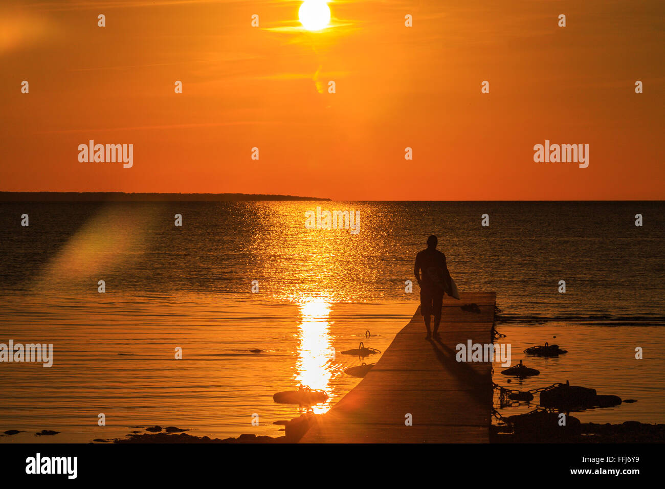 Man Surfing sunset Stock Photo - Alamy