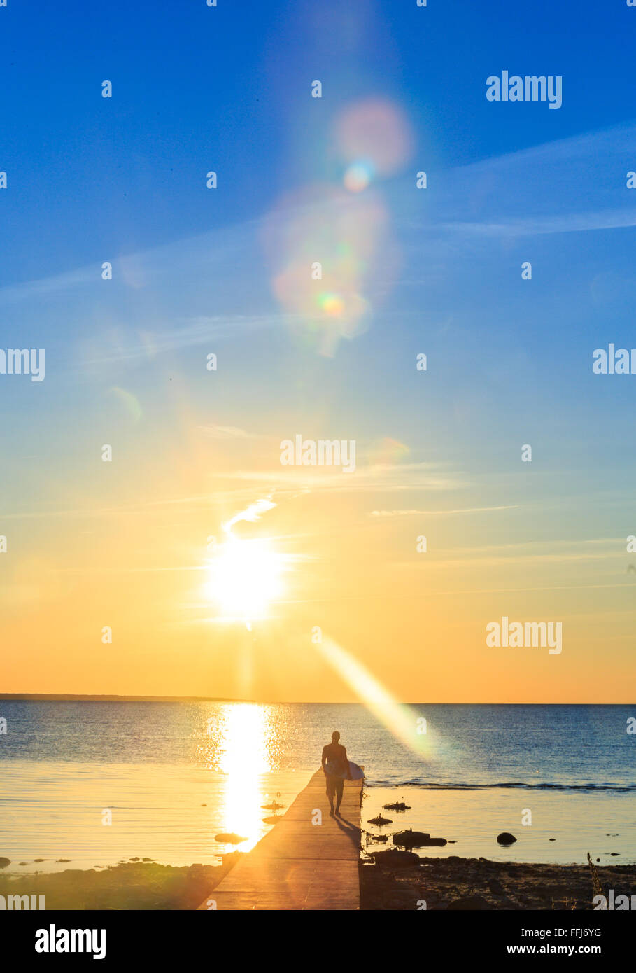 Man Surfing sunset Stock Photo - Alamy