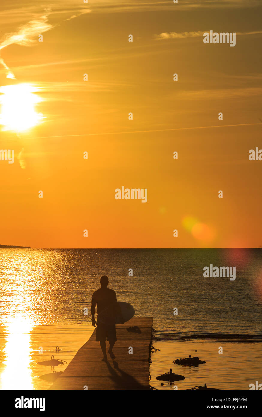 Man Surfing sunset Stock Photo - Alamy