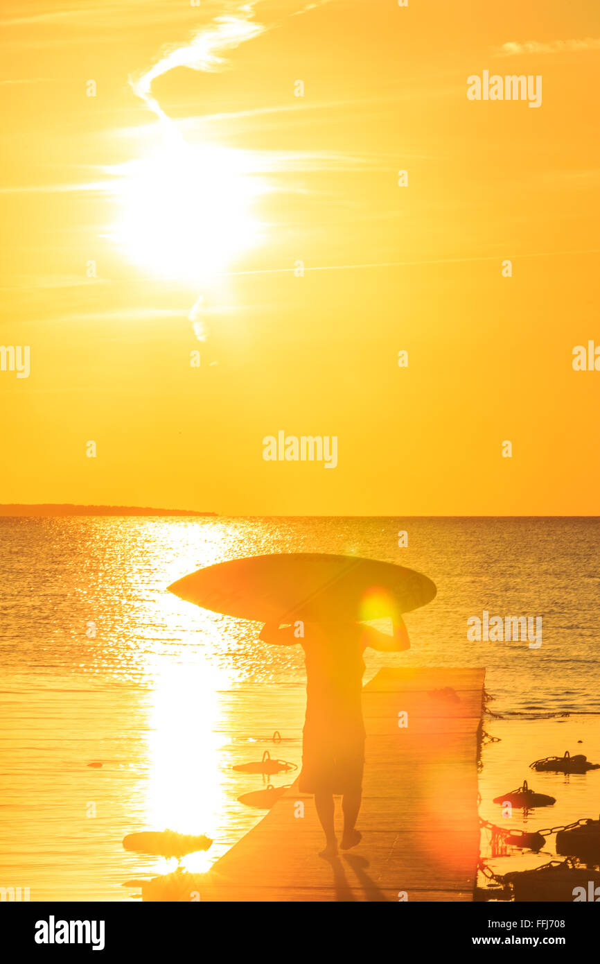 Man Surfing sunset Stock Photo - Alamy