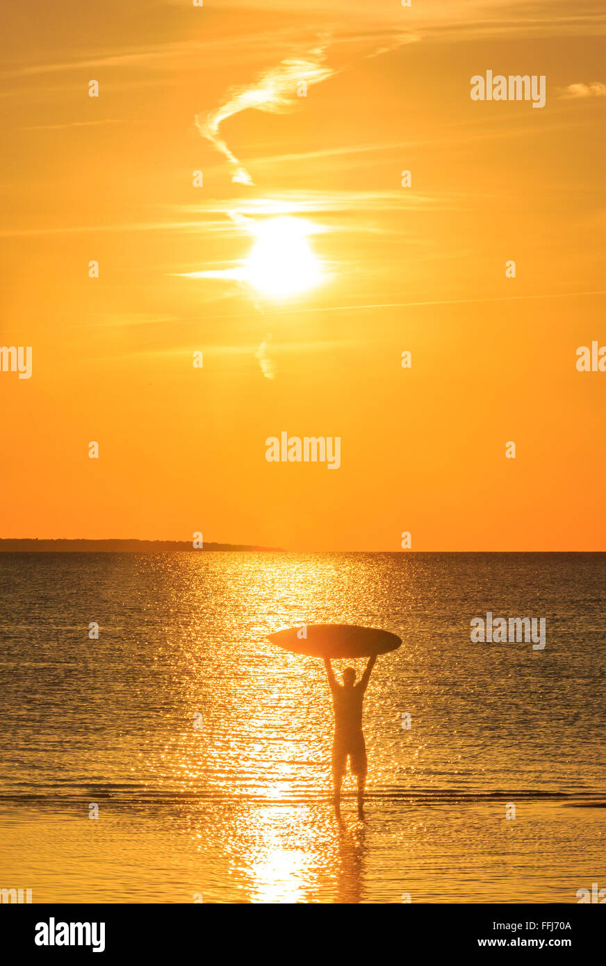 Man Surfing sunset Stock Photo - Alamy