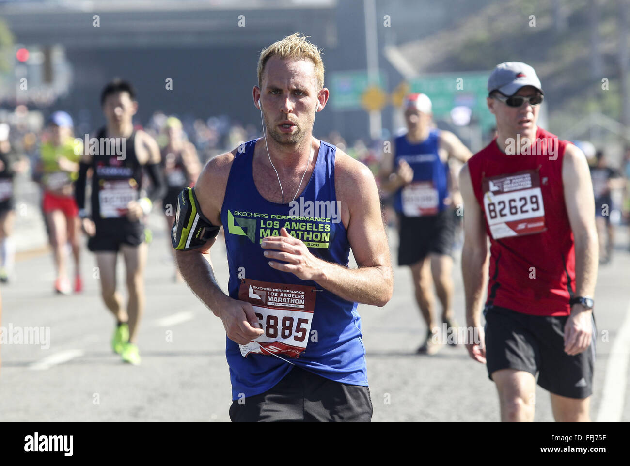Los Angeles, California, USA. 14th Feb, 2016. Runners make their way ...