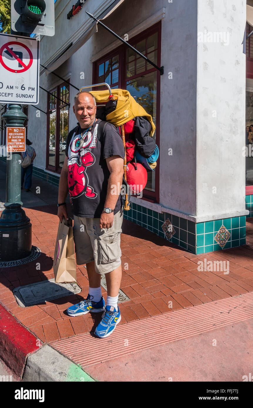 An older transient male backpacker carries his world possessions on his ...