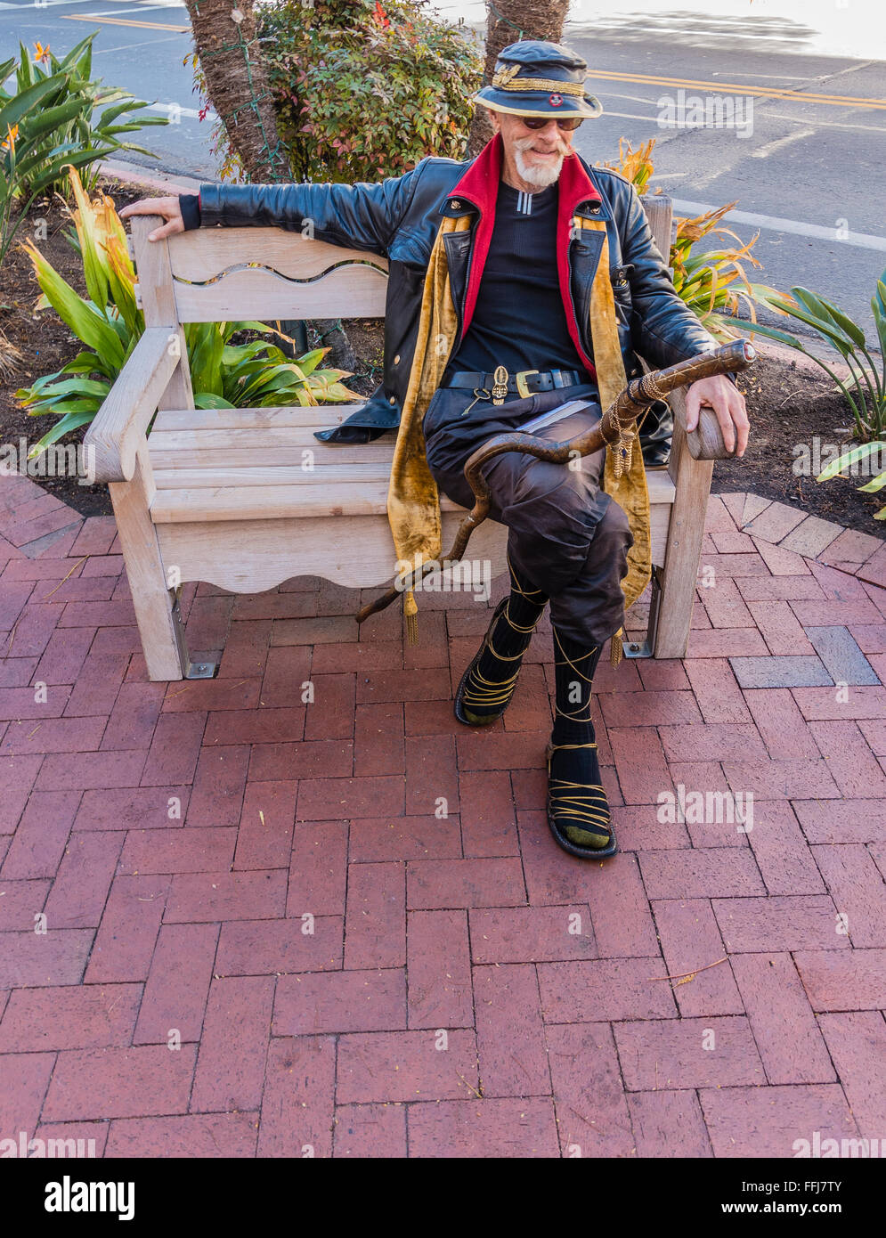 An elderly, eccentric street character sits on a public bench on State ...