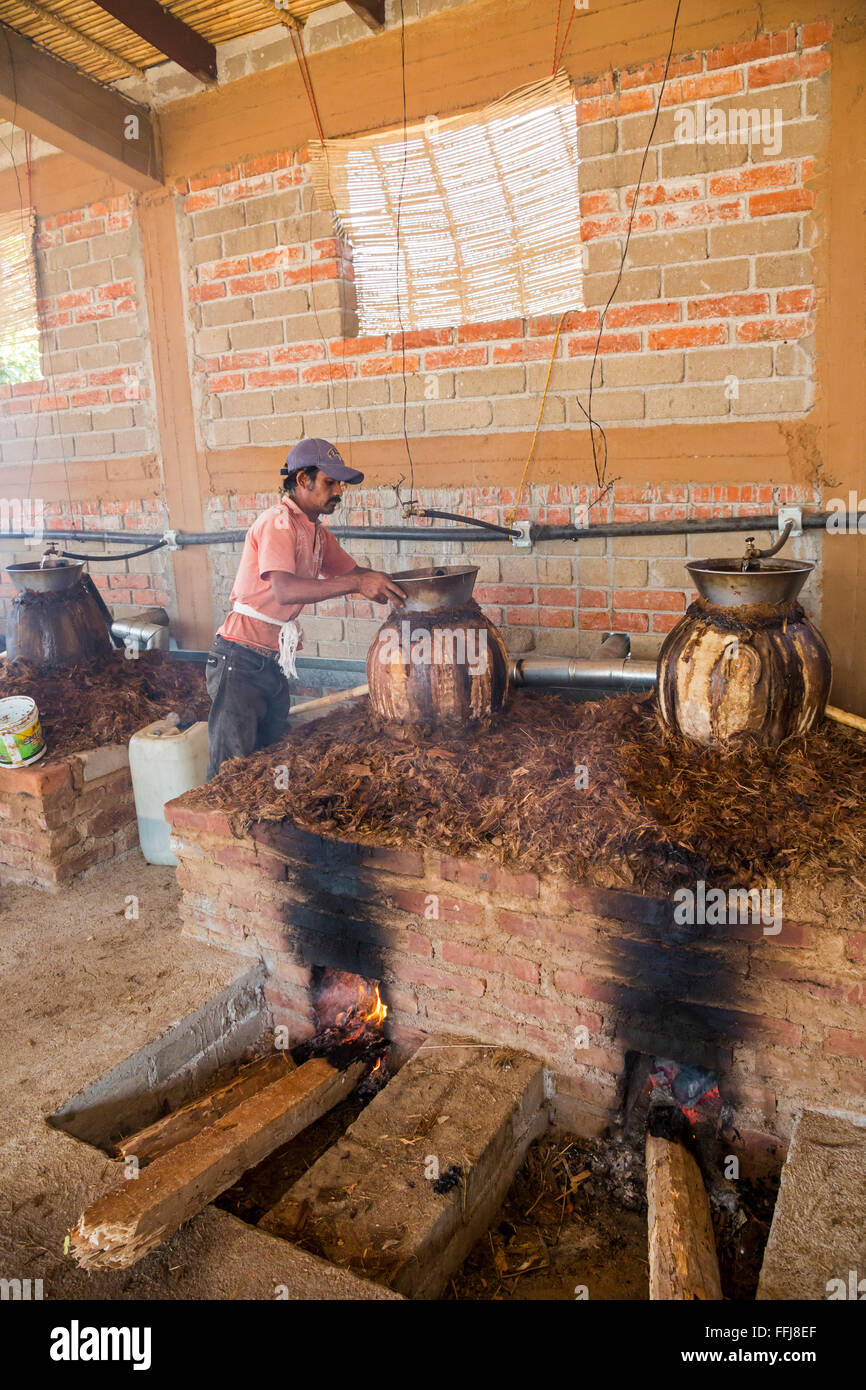Santa Catarina Minas, Oaxaca, Mexico - Mezcal distillery. A worker fits ...