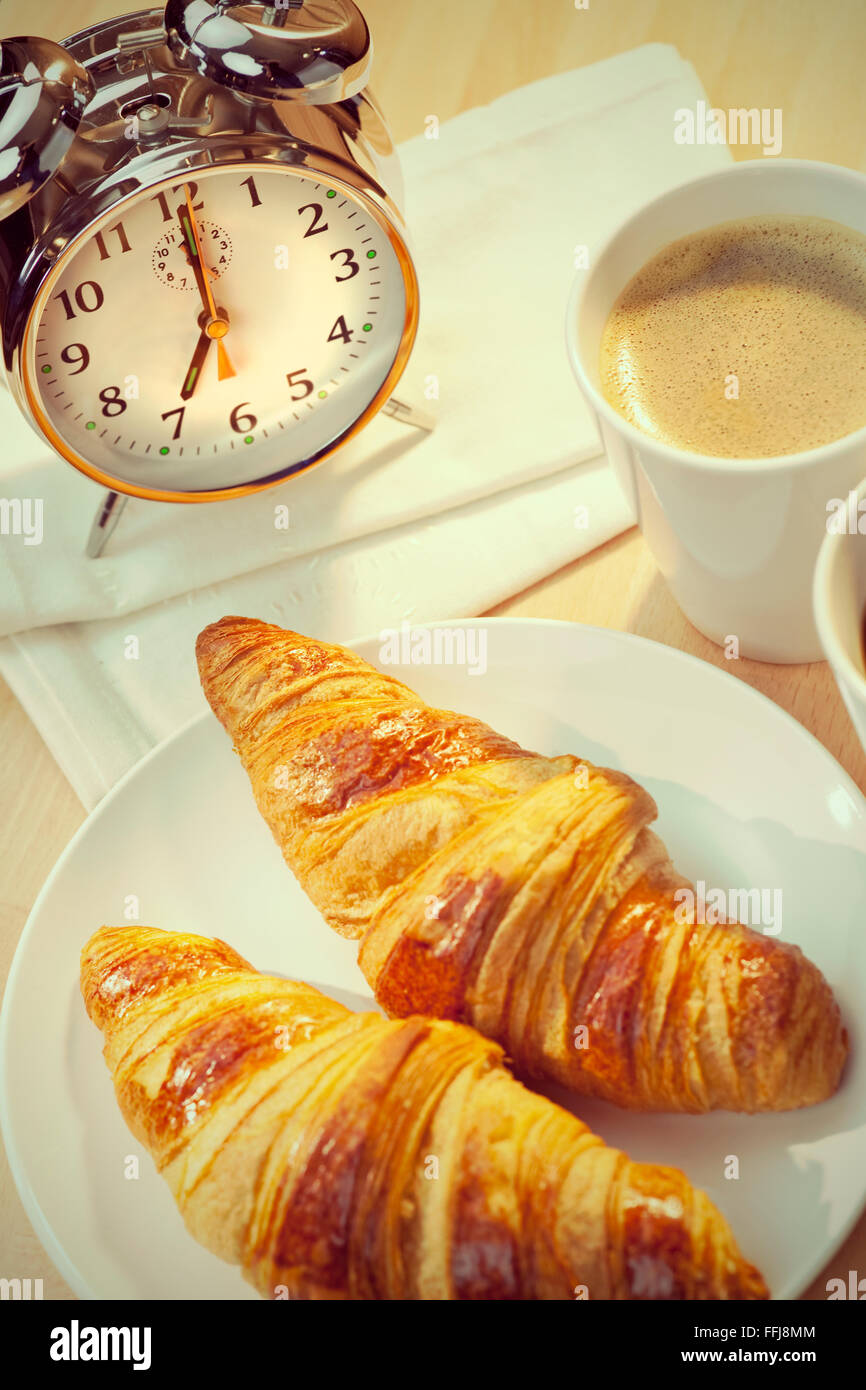 A continental breakfast of croissant pastries and coffee in golden ...