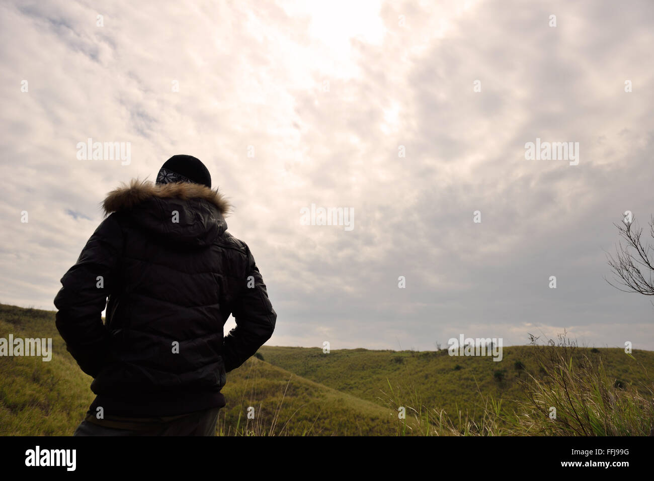 Young man wearing a jacket alone Stock Photo - Alamy
