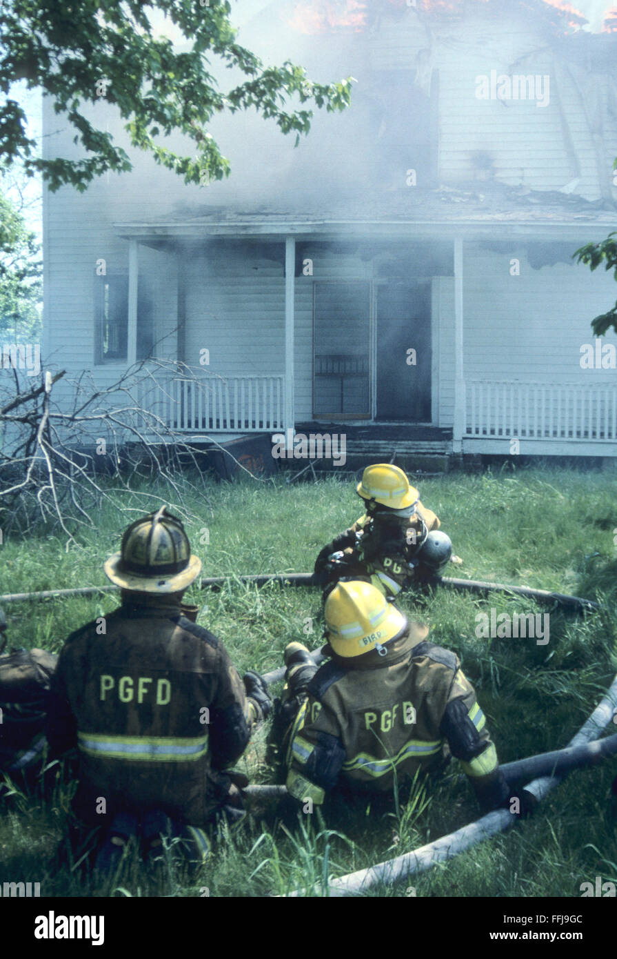 Firefighters fighting a house fire Stock Photo - Alamy