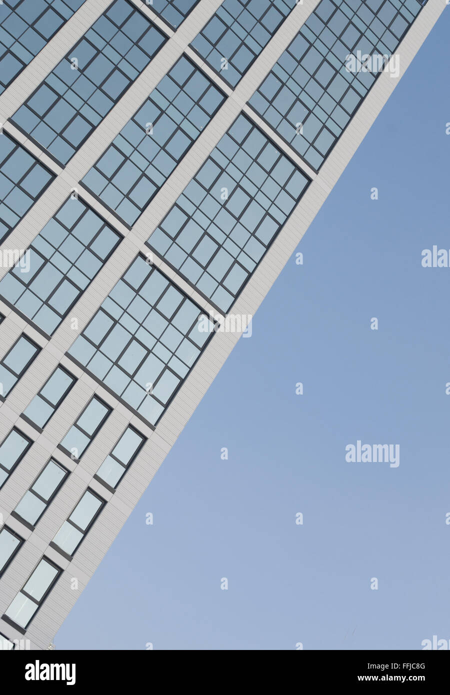 Modern glass high-rise office building with acute angles showing ...