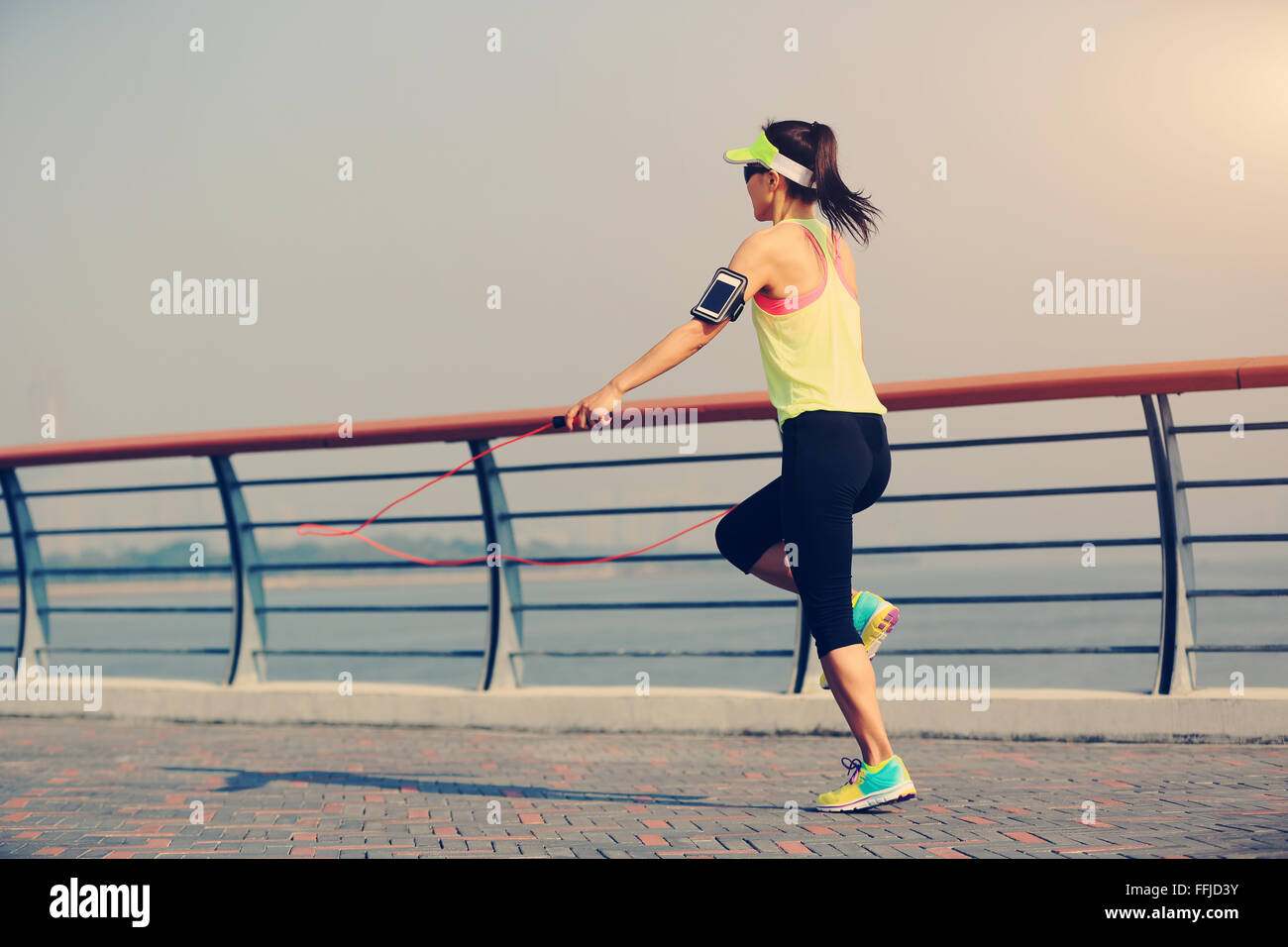 young fitness woman jumping rope at seaside Stock Photo - Alamy