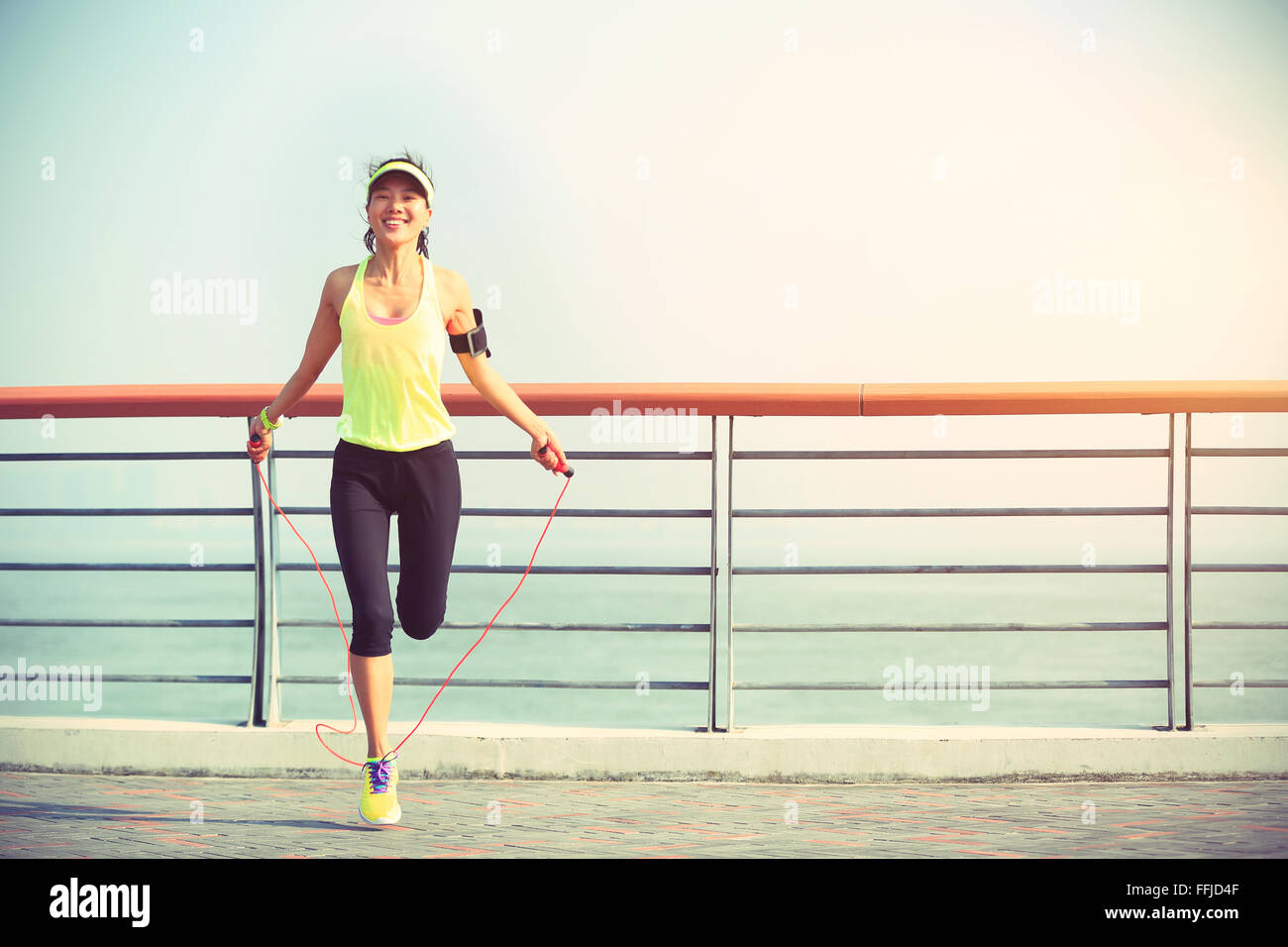 young fitness woman jumping rope at seaside Stock Photo - Alamy