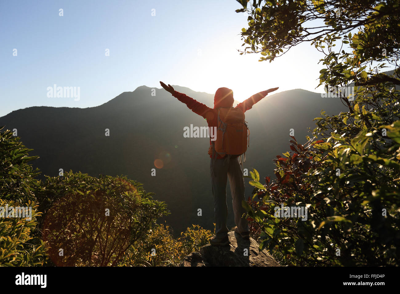 successful woman hiker open arms on sunrise mountain peak Stock Photo ...