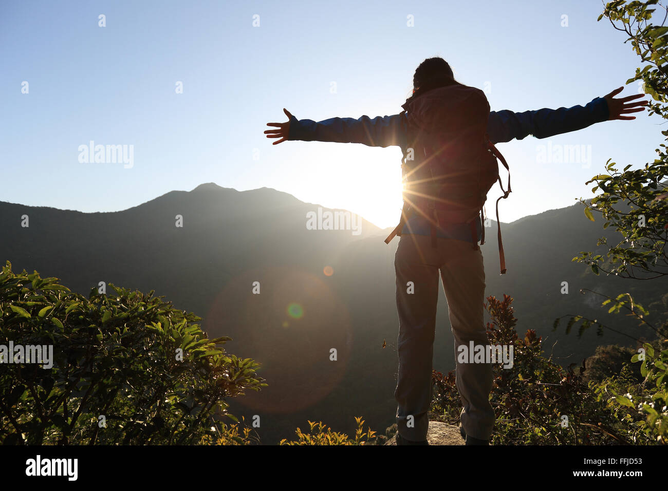 successful woman hiker open arms on sunrise mountain peak Stock Photo ...