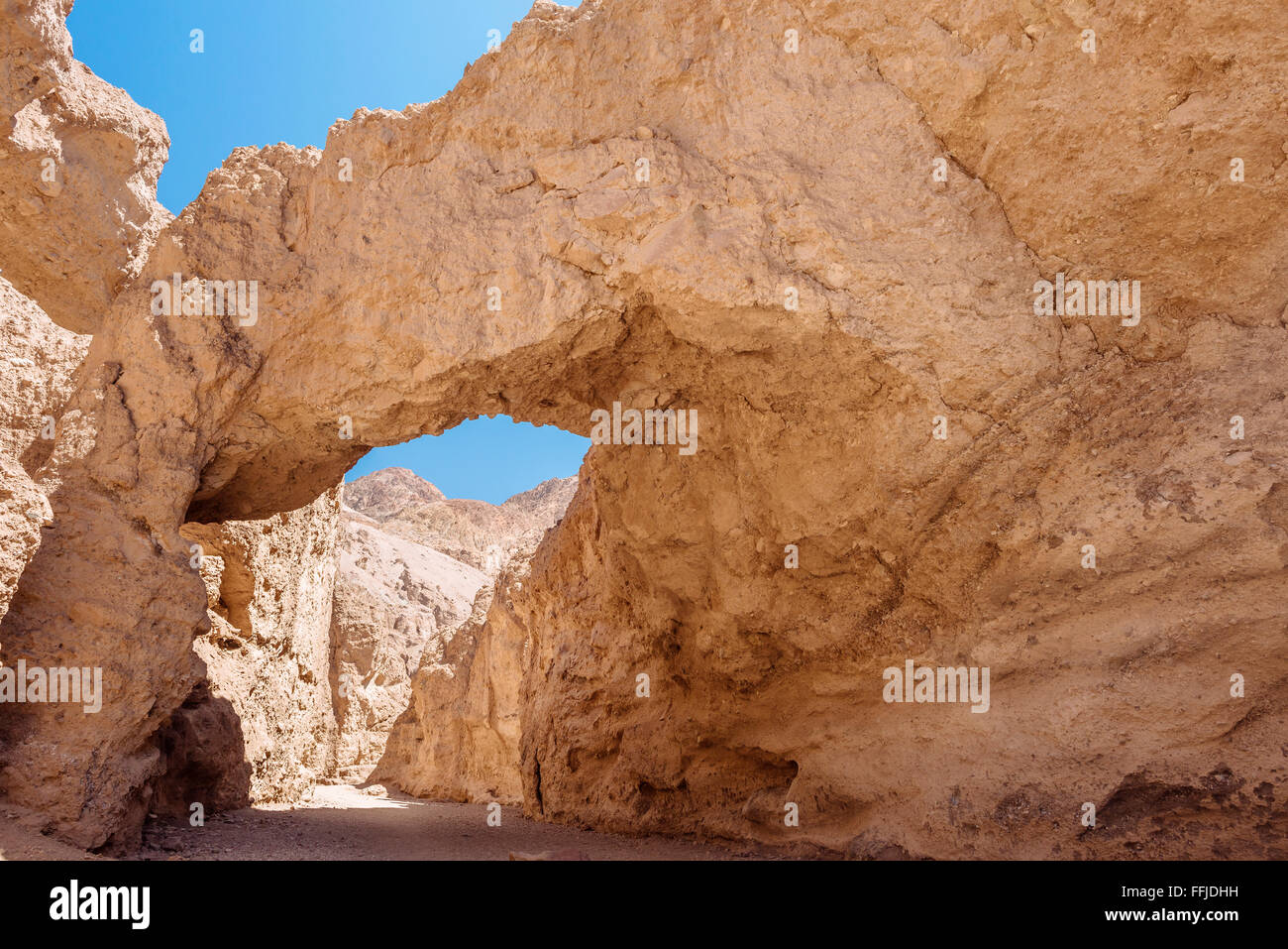 A rock arch in Natural Bridge Canyon, Death Valley National Park ...
