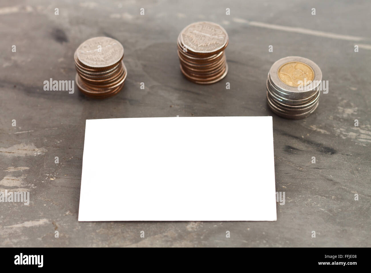 Blank name card with coins, stock photo Stock Photo - Alamy