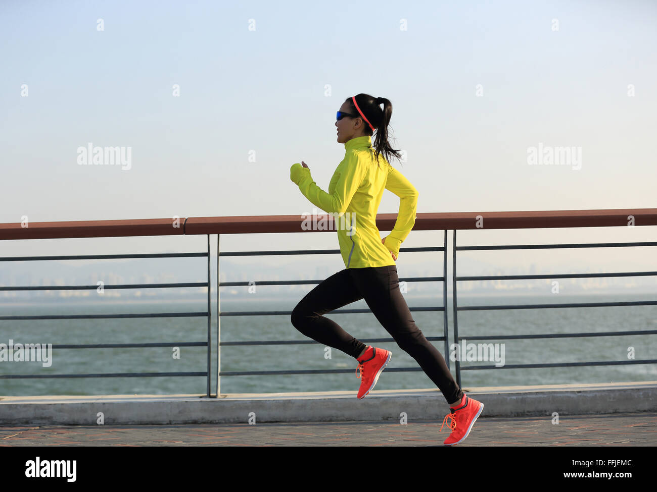 young fitness woman runner running on seaside Stock Photo - Alamy