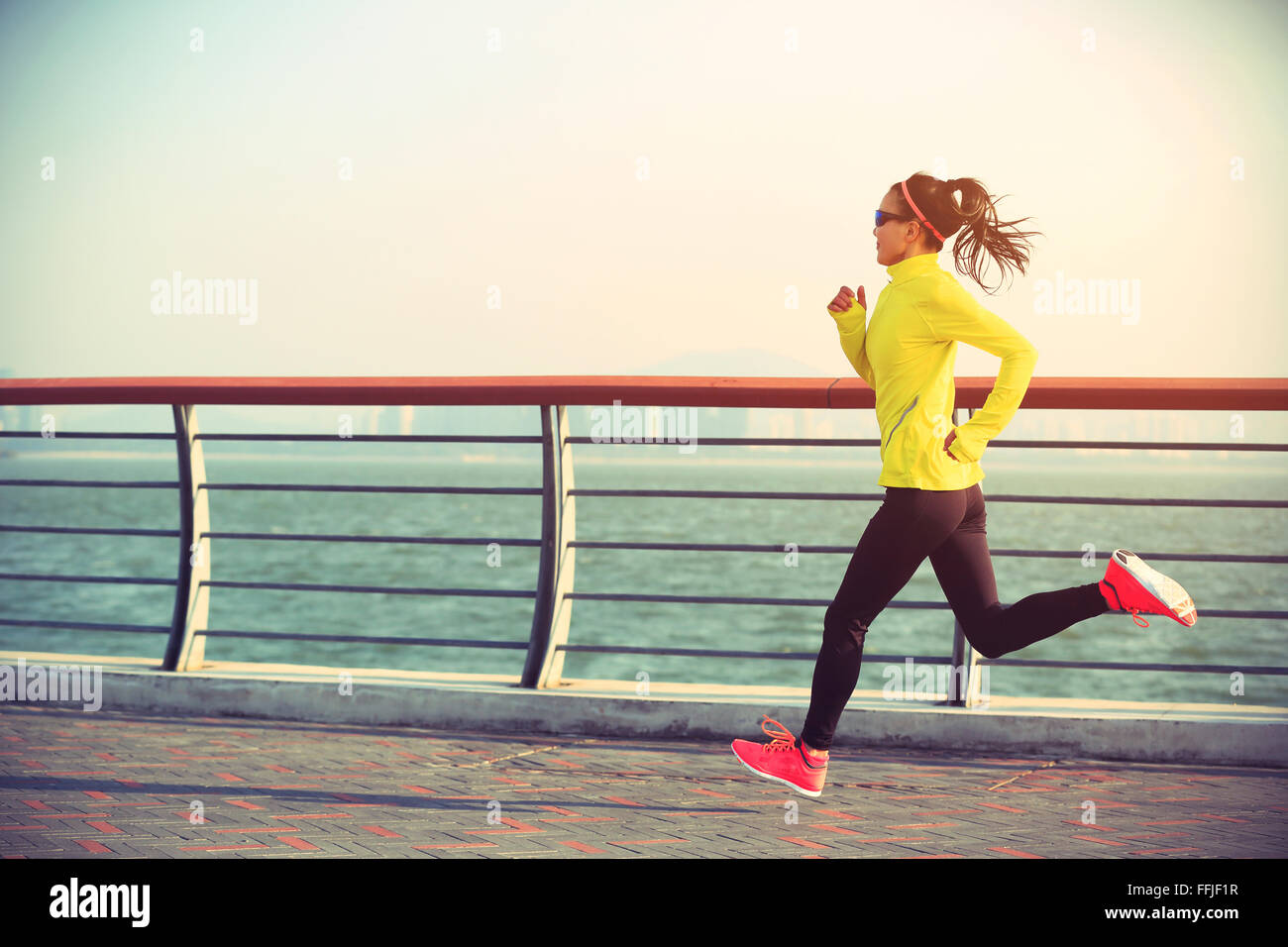 young fitness woman runner running on seaside Stock Photo - Alamy