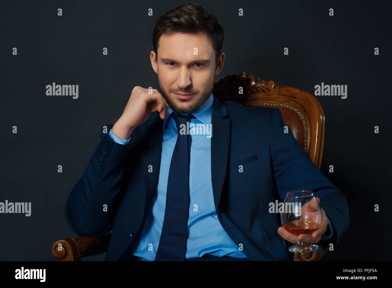 Handsome businessman drinking alcohol Stock Photo - Alamy
