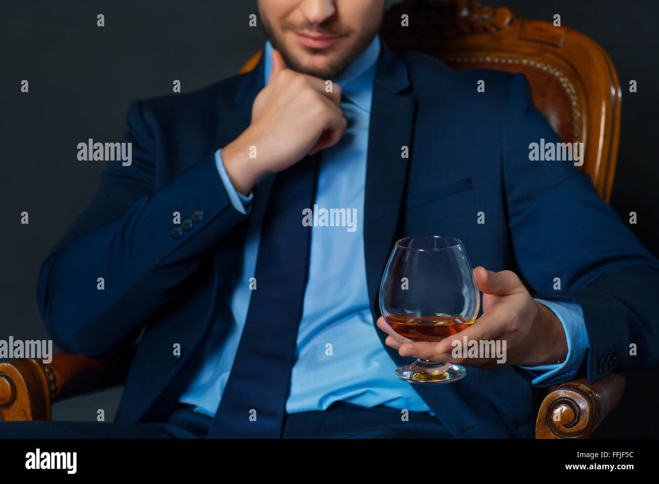Handsome businessman drinking alcohol Stock Photo - Alamy