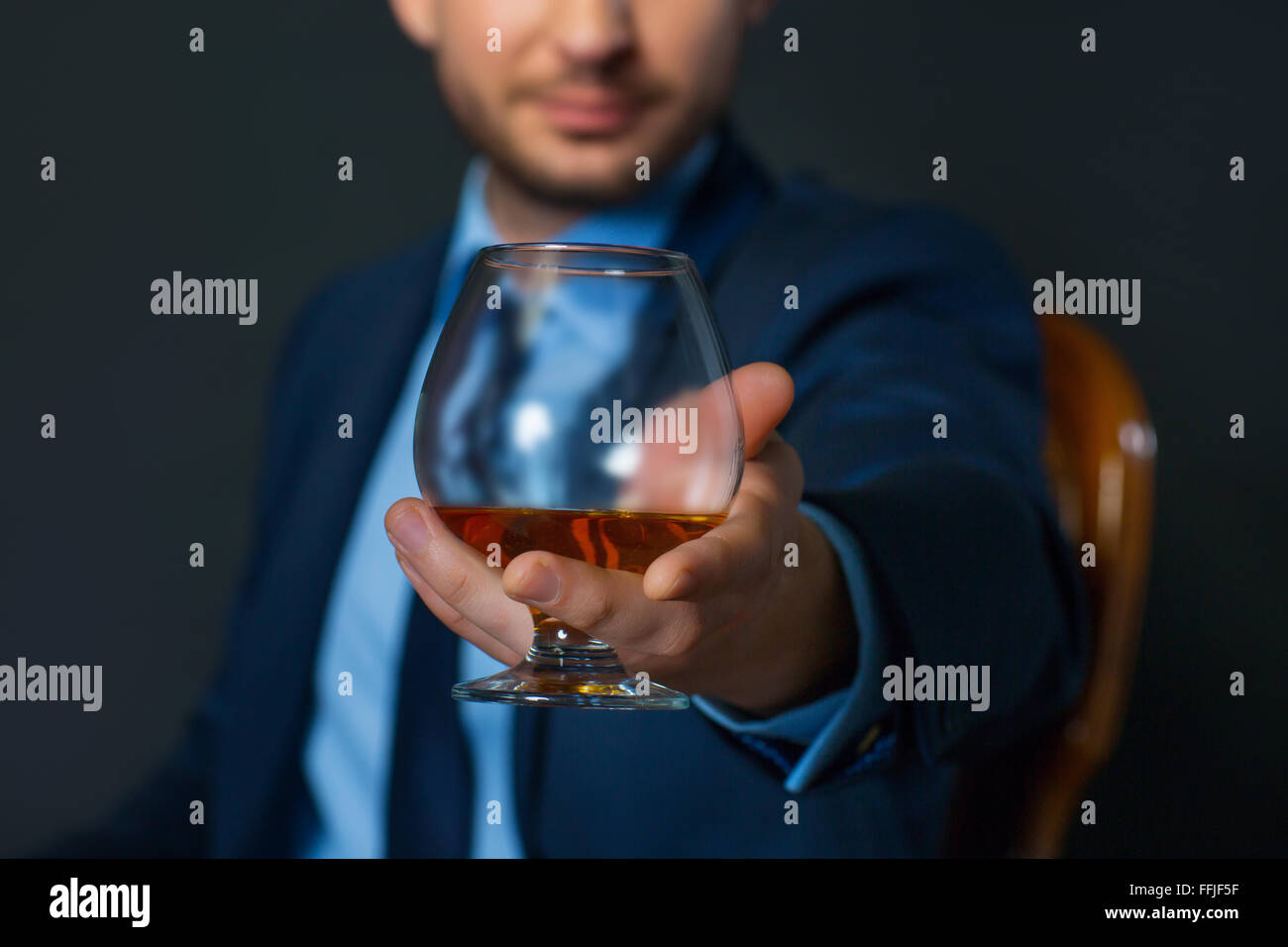 Handsome businessman drinking alcohol Stock Photo - Alamy