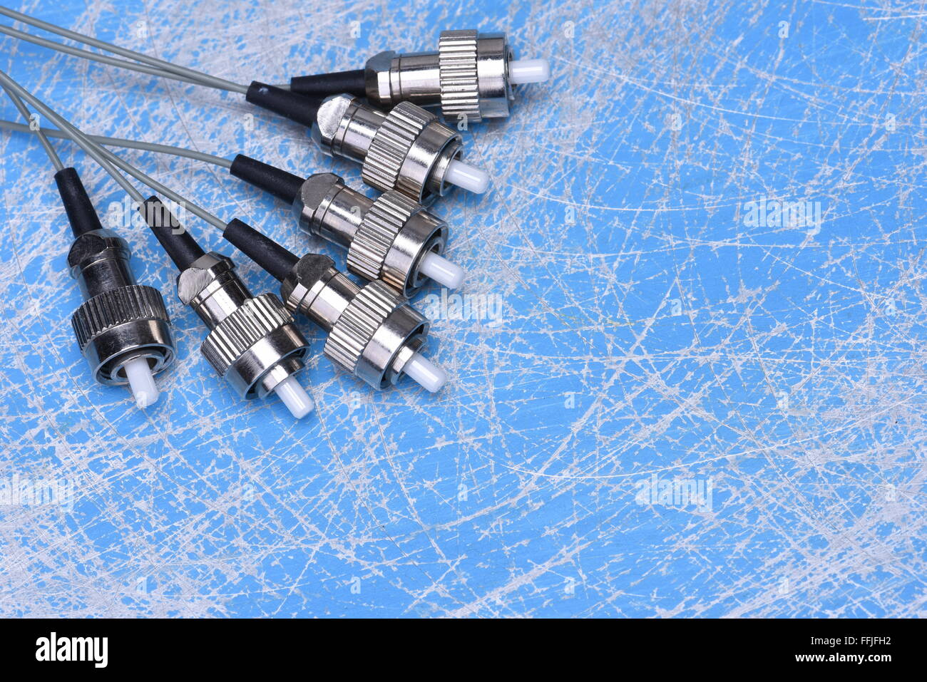 Fiber optic cable pigtails on blue background Stock Photo - Alamy