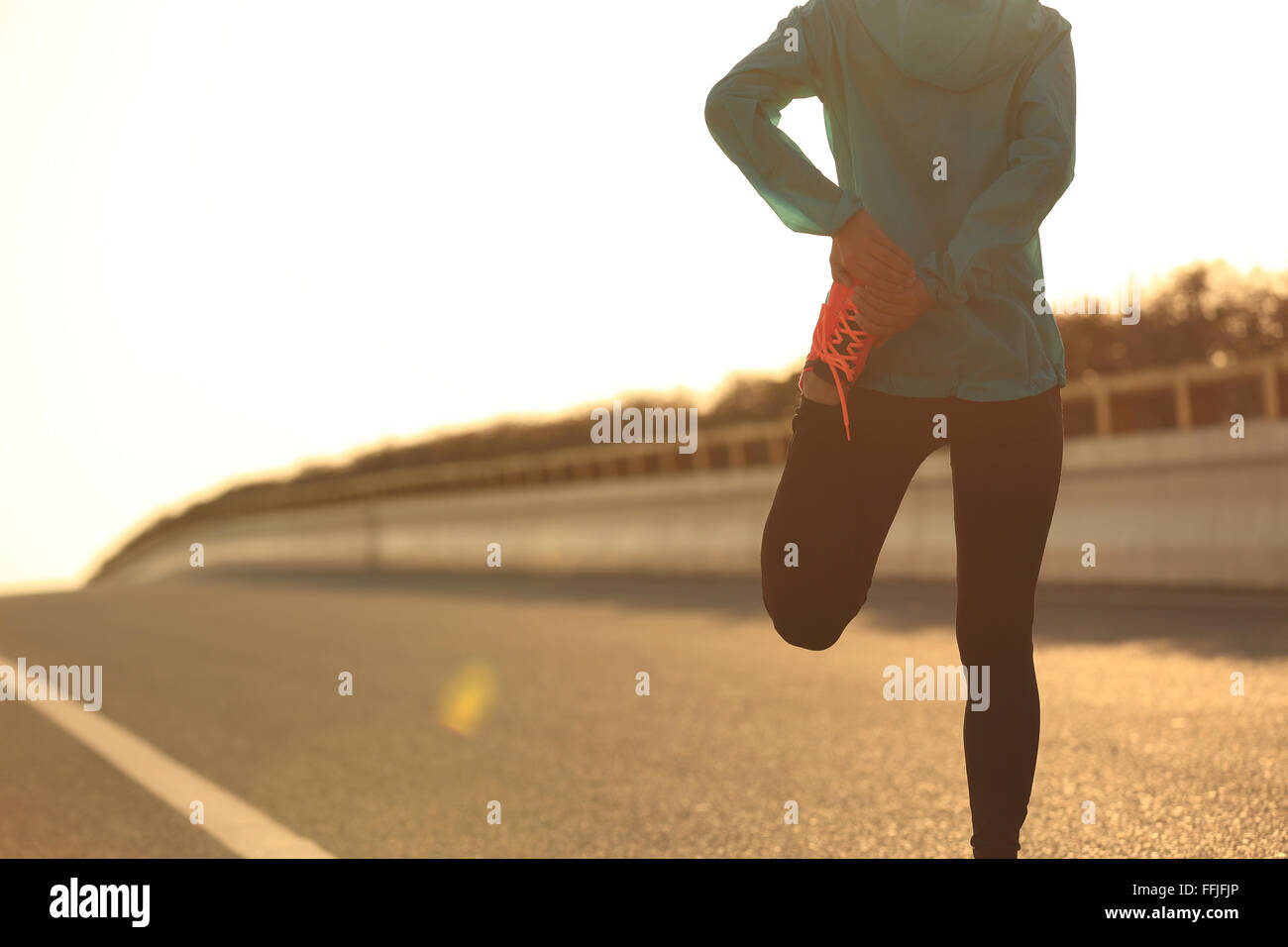 young fitness woman runner stretching legs before run Stock Photo - Alamy