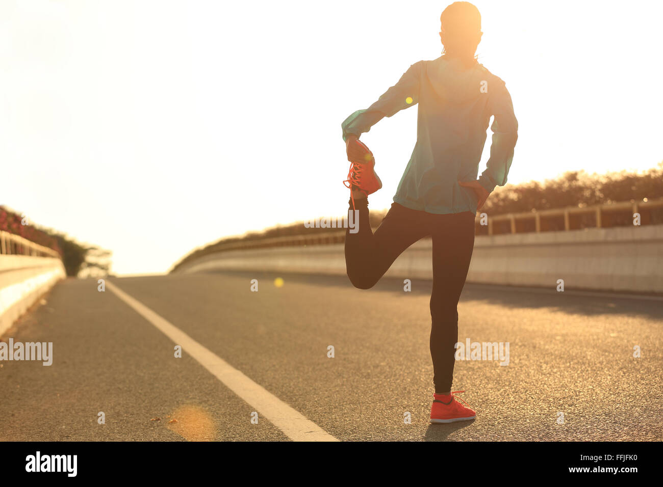 young fitness woman runner stretching legs before run Stock Photo - Alamy
