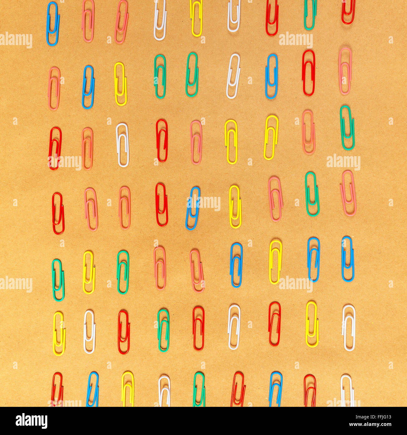 Flat lay colorful paper clips arrangement on kraft paper background ...