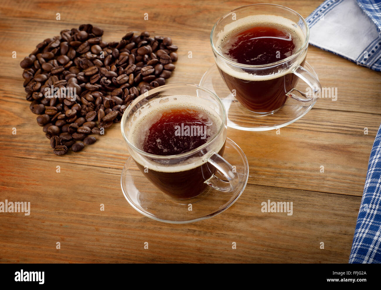 Two glass cups of coffee on rustic wooden background. View from above ...